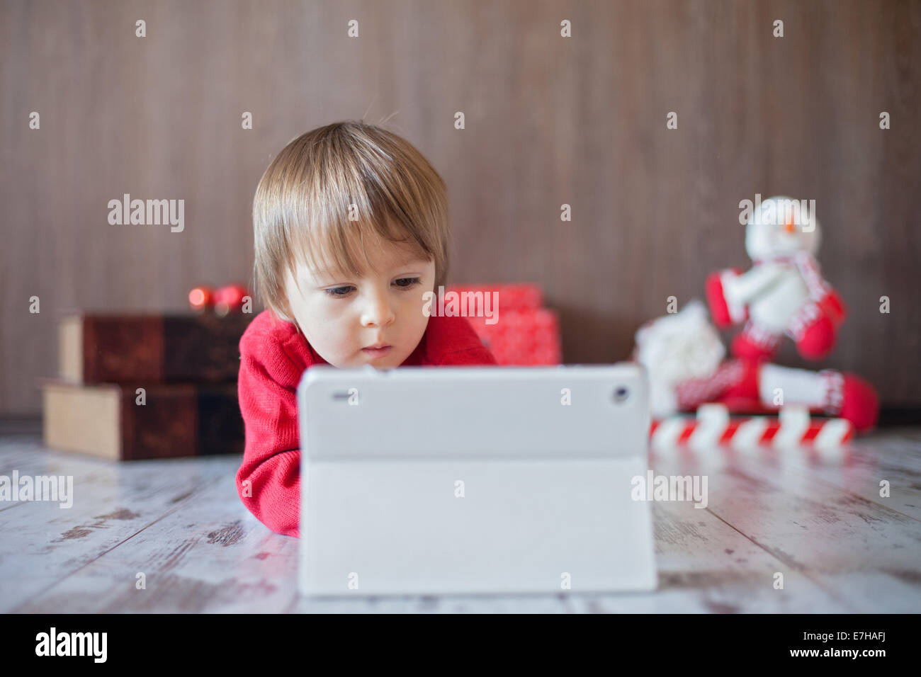 Little boy, playing on tablet Stock Photo - Alamy