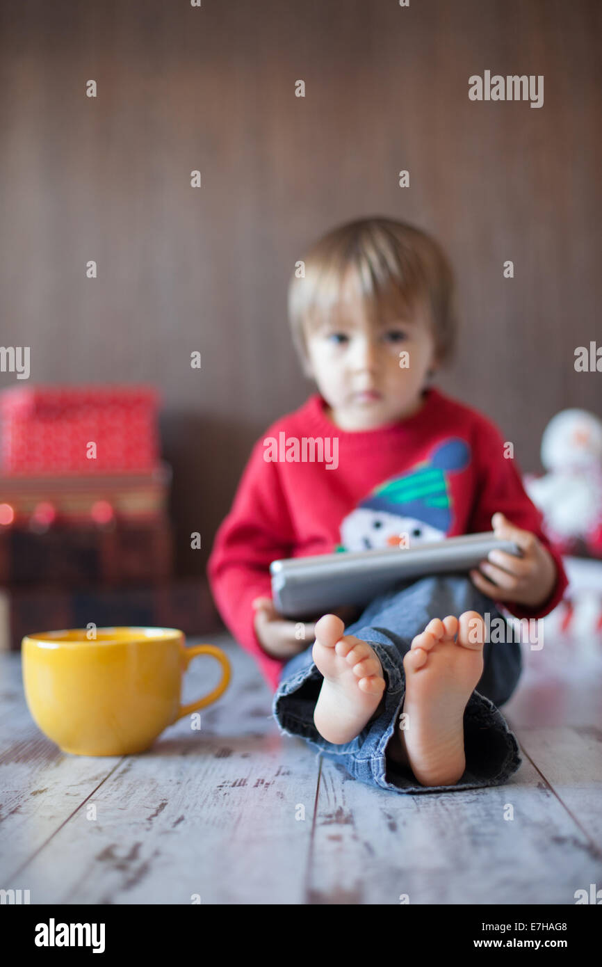 Little boy, playing on tablet Stock Photo - Alamy