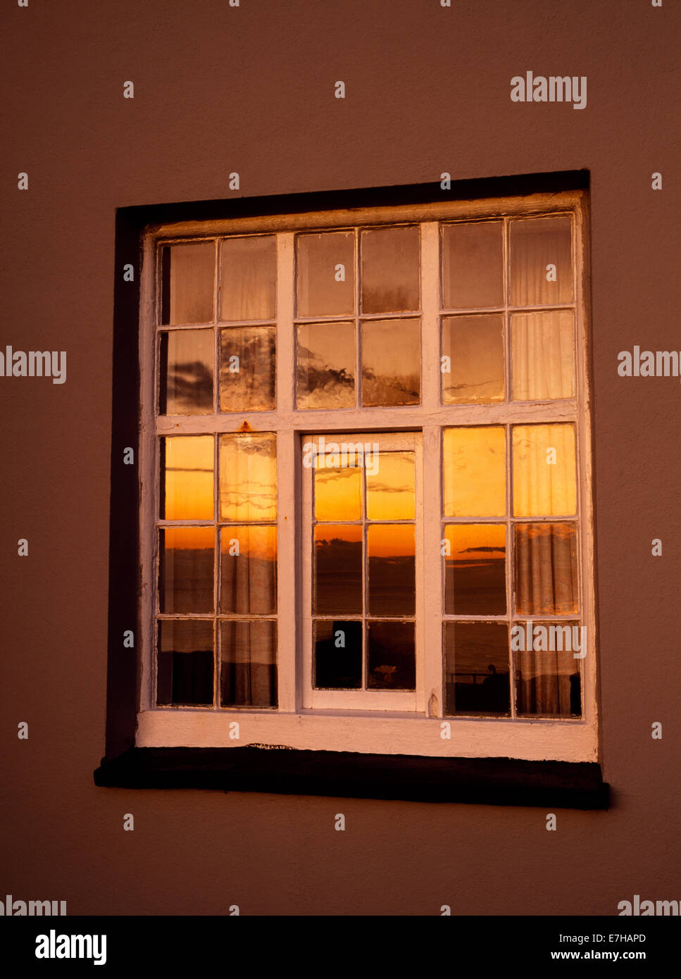 Sunset and western horizon reflected in Victorian wooden window, Hendy ...