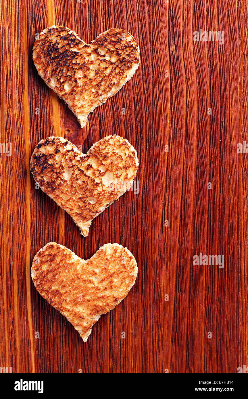 Toast bread in shape of hearts on wooden background Stock Photo - Alamy