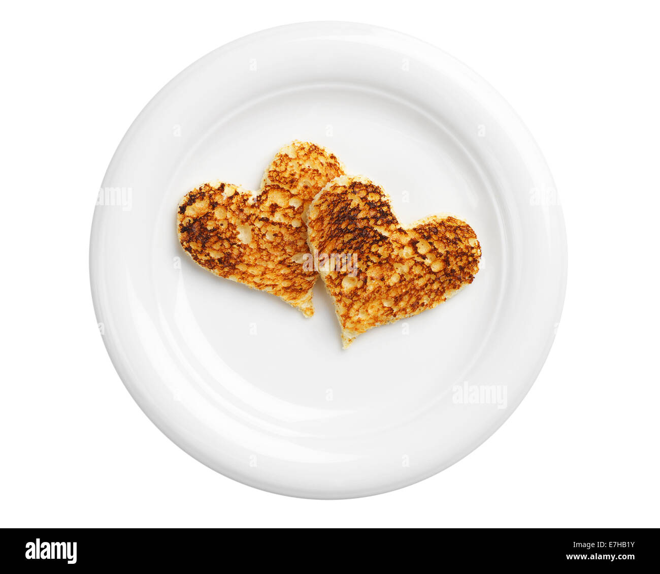 Two toast bread in the shape of hearts in a plate isolated on white ...
