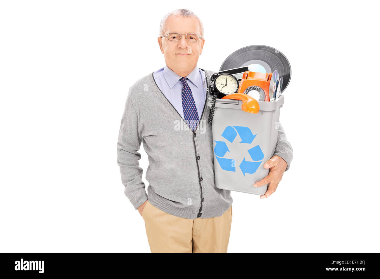 Senior man holding a recycle bin full of old stuff isolated on white ...