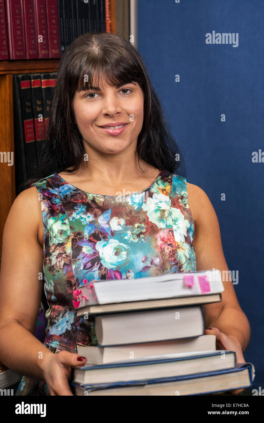 A young woman finding books in a study library Stock Photo - Alamy