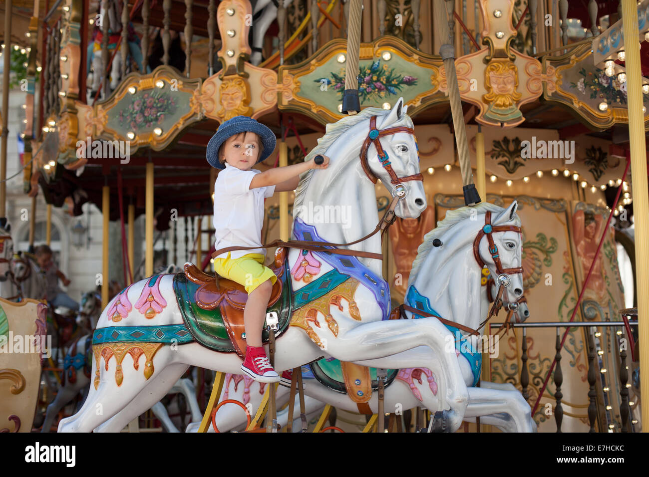 Cute kid, riding on a carousel, Europe Stock Photo - Alamy