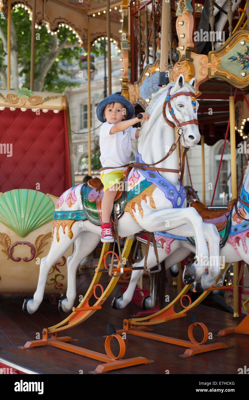 Cute kid, riding on a carousel, Europe Stock Photo - Alamy