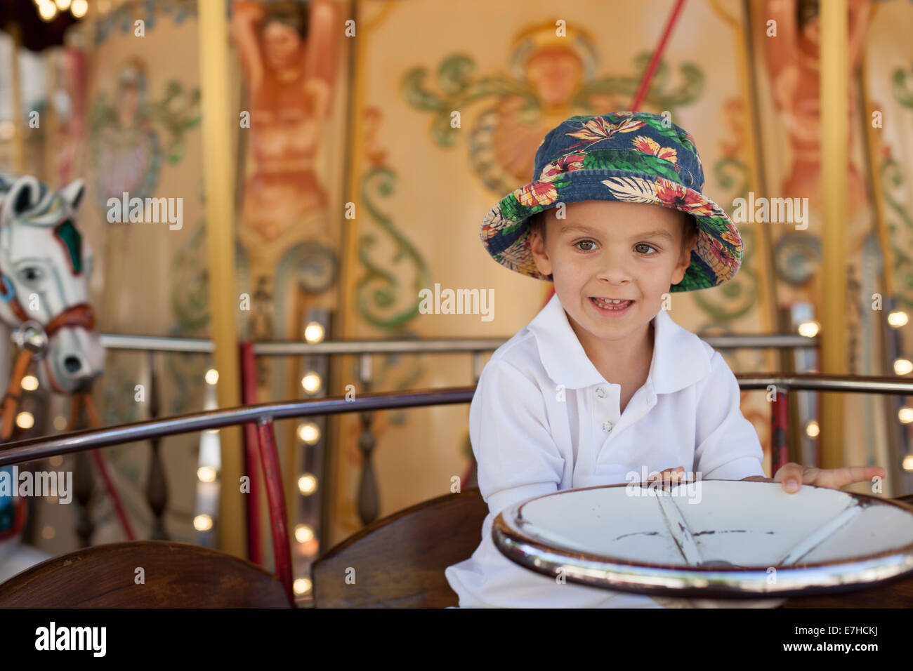 Cute kid, riding on a carousel, Europe Stock Photo - Alamy