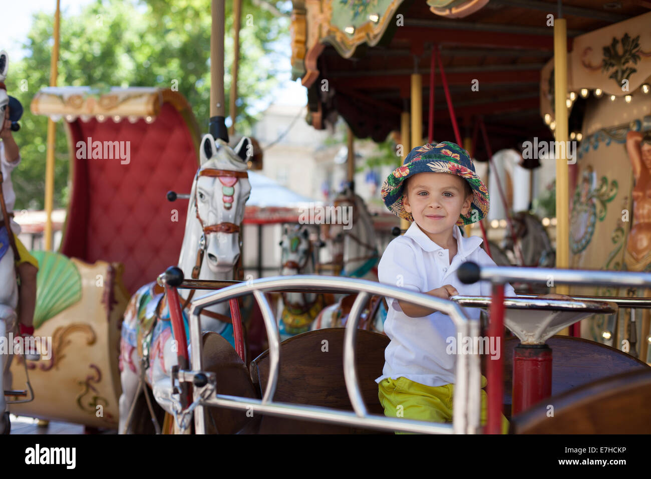 Cute kid, riding on a carousel, Europe Stock Photo - Alamy
