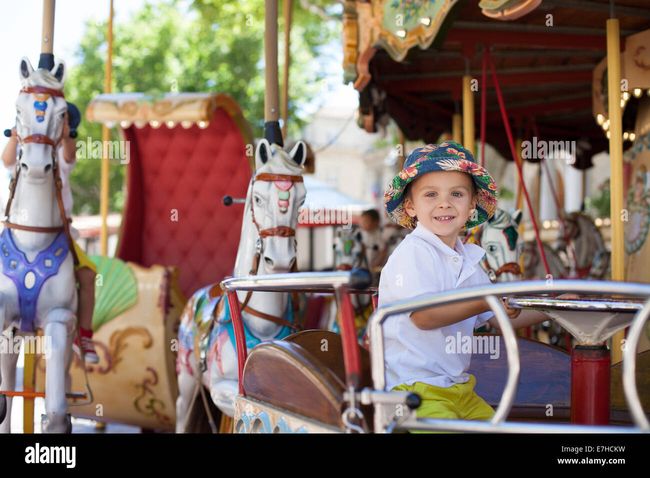 Cute kid, riding on a carousel, Europe Stock Photo - Alamy