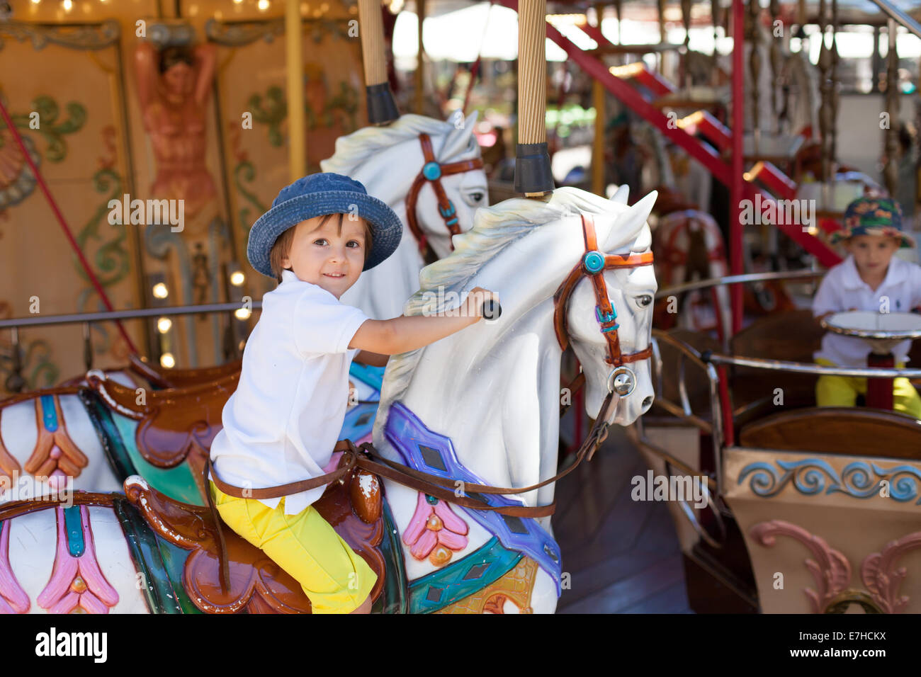Cute kid, riding on a carousel, Europe Stock Photo - Alamy