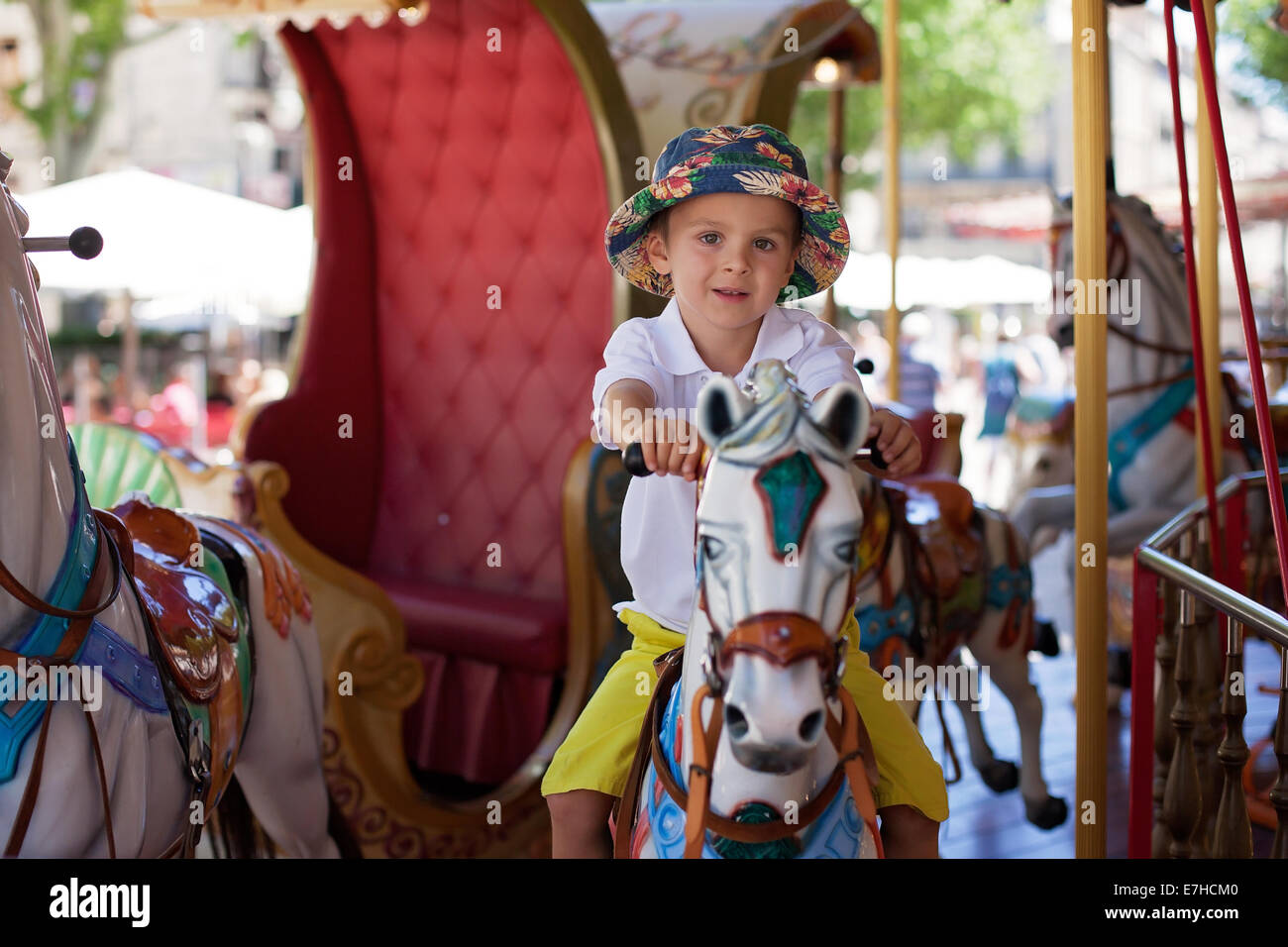 Cute kid, riding on a carousel, Europe Stock Photo - Alamy