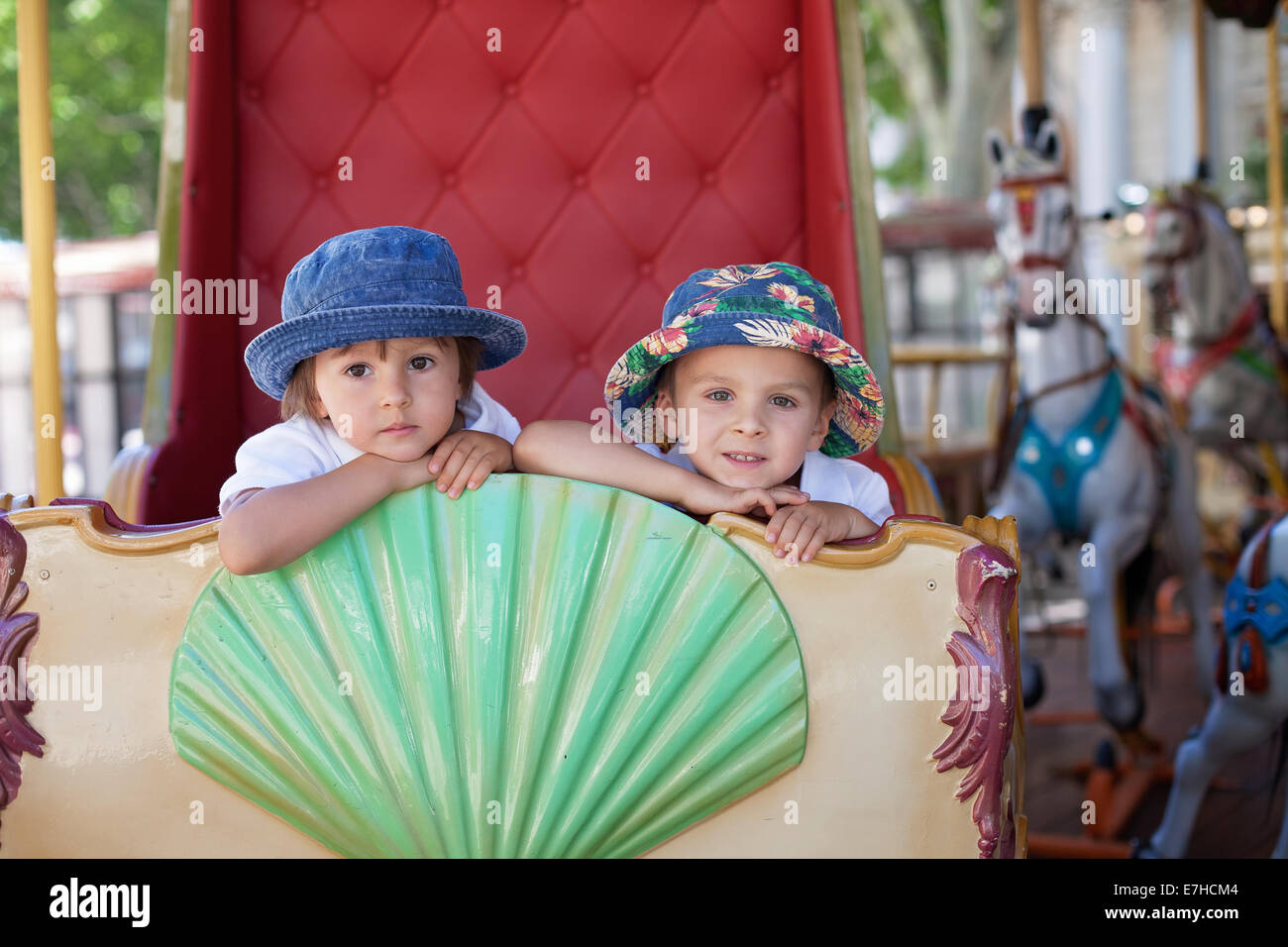 Cute kids, riding on a carousel in Europe Stock Photo - Alamy