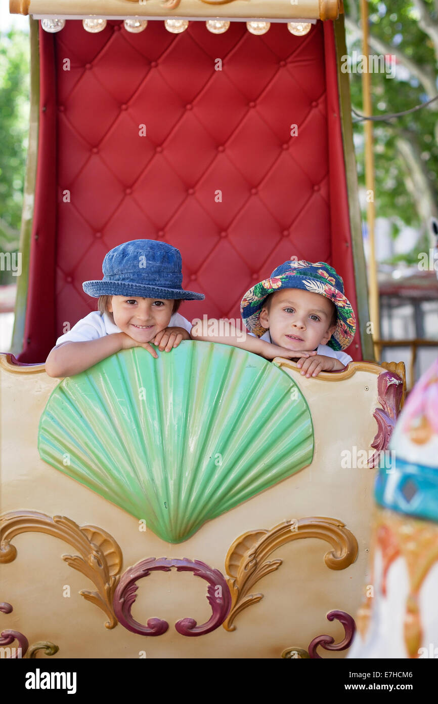 Cute kids, riding on a carousel in Europe Stock Photo - Alamy