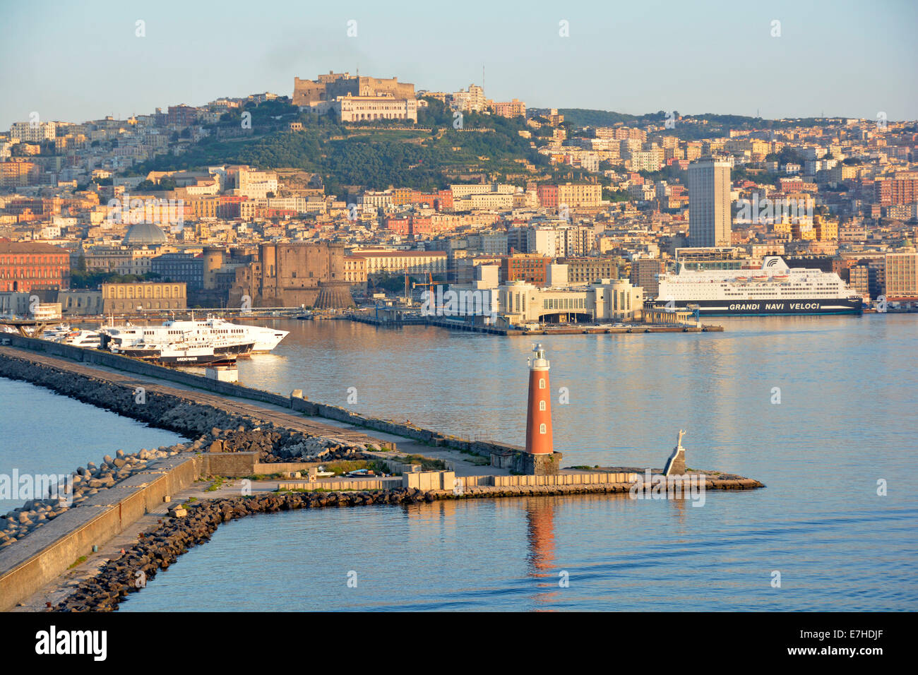 Early morning sunshine looking down on the port and city of Naples with ...