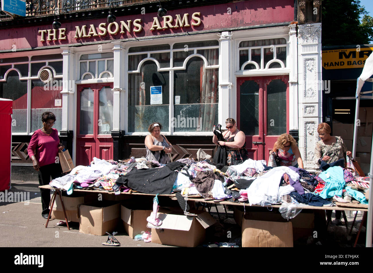 Second hand clothes stall in East Lane market South London Stock Photo ...