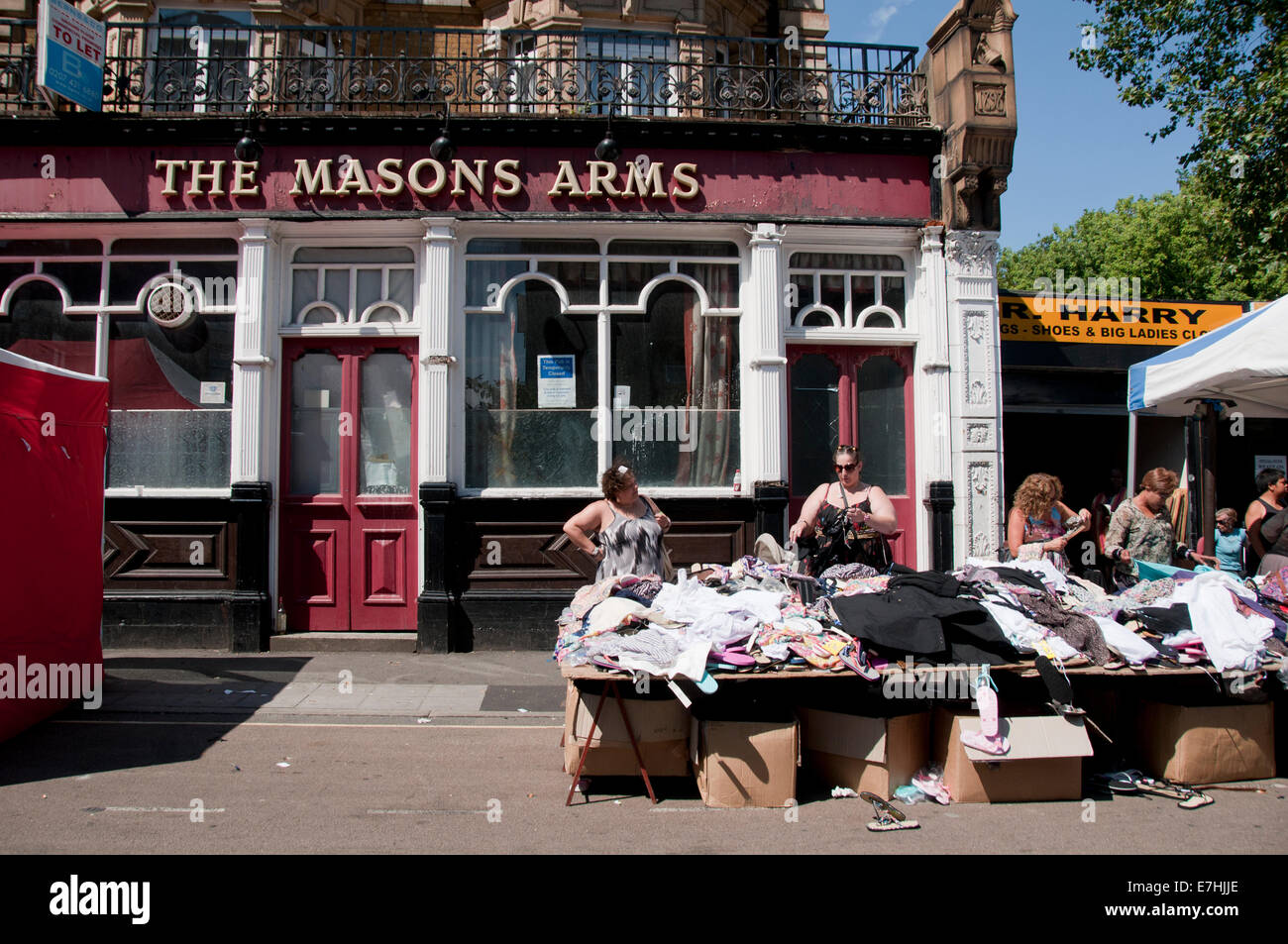 Second hand clothes stall in East Lane market South London Stock Photo ...