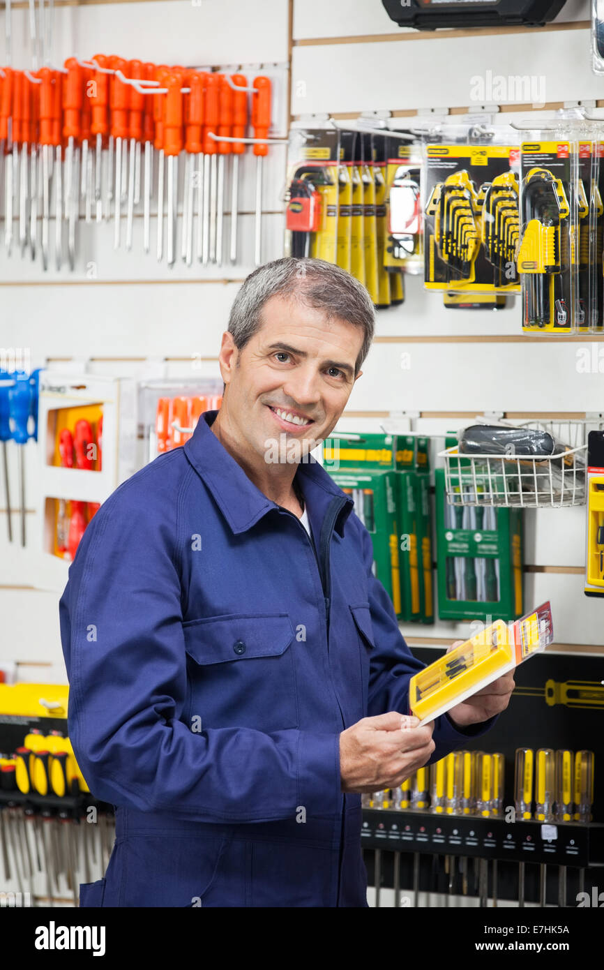 Worker Holding Tool Package In Hardware Shop Stock Photo - Alamy