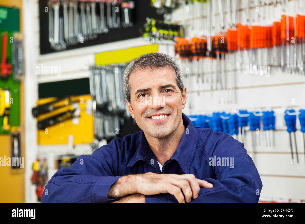 Male Worker Leaning In Hardware Shop Stock Photo - Alamy