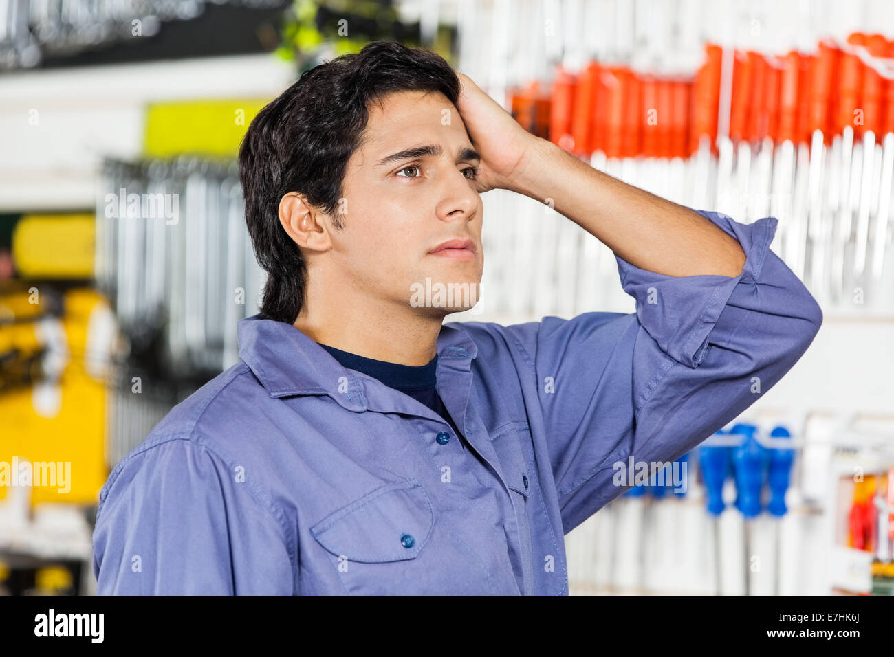 Confused Customer Looking Away In Hardware Shop Stock Photo - Alamy