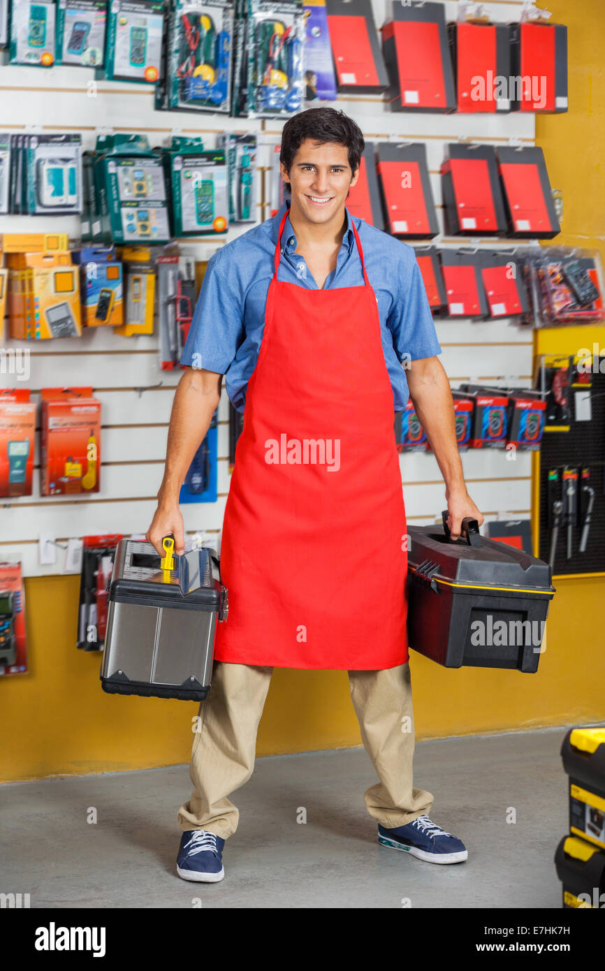 Confident Salesman Holding Toolboxes In Store Stock Photo - Alamy