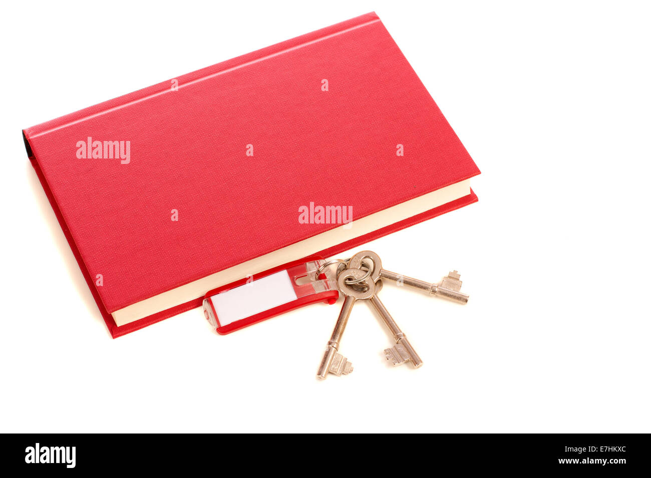 Book and some keys isolated over white background Stock Photo - Alamy