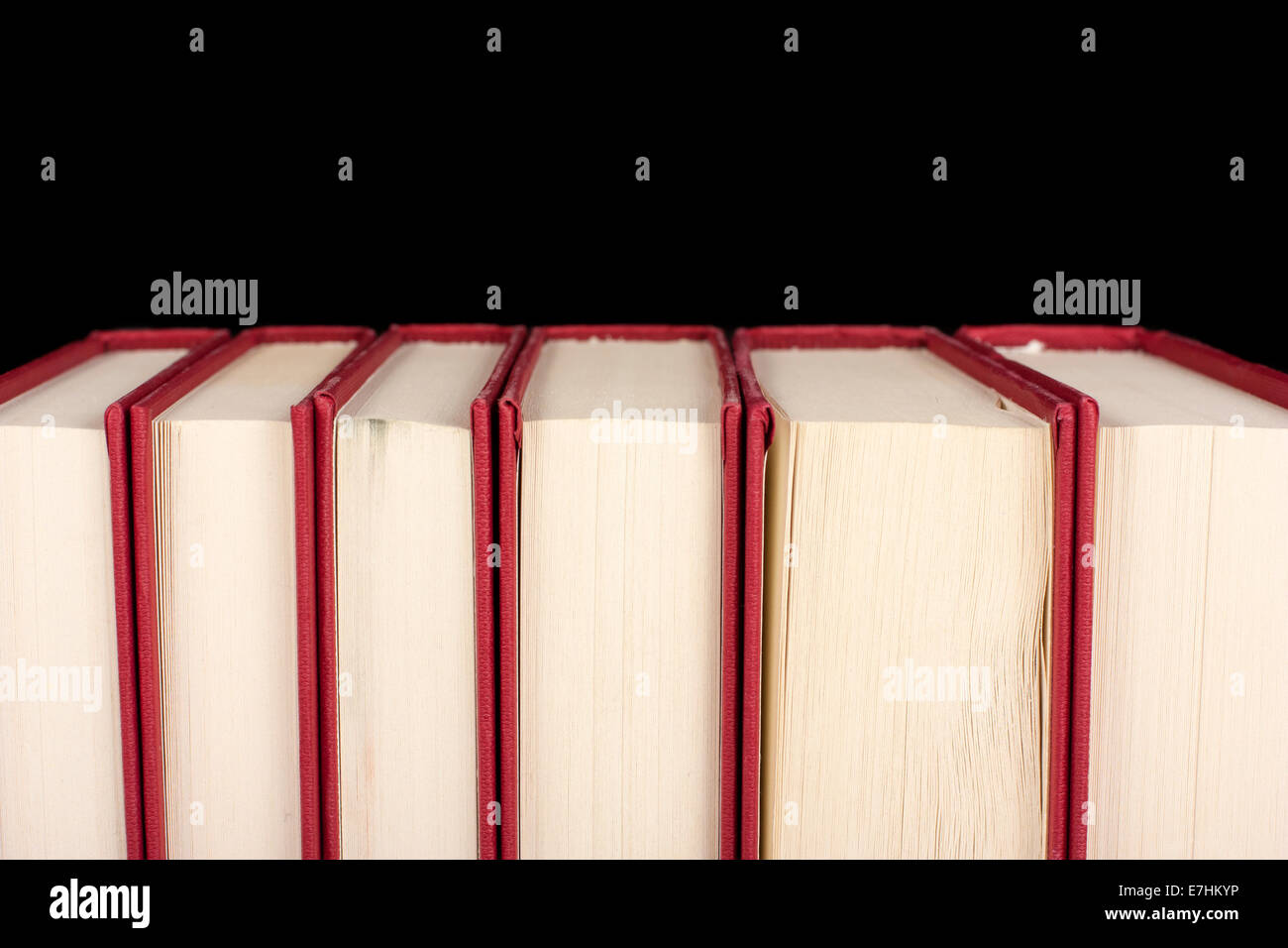 A row of books isolated over black background Stock Photo - Alamy
