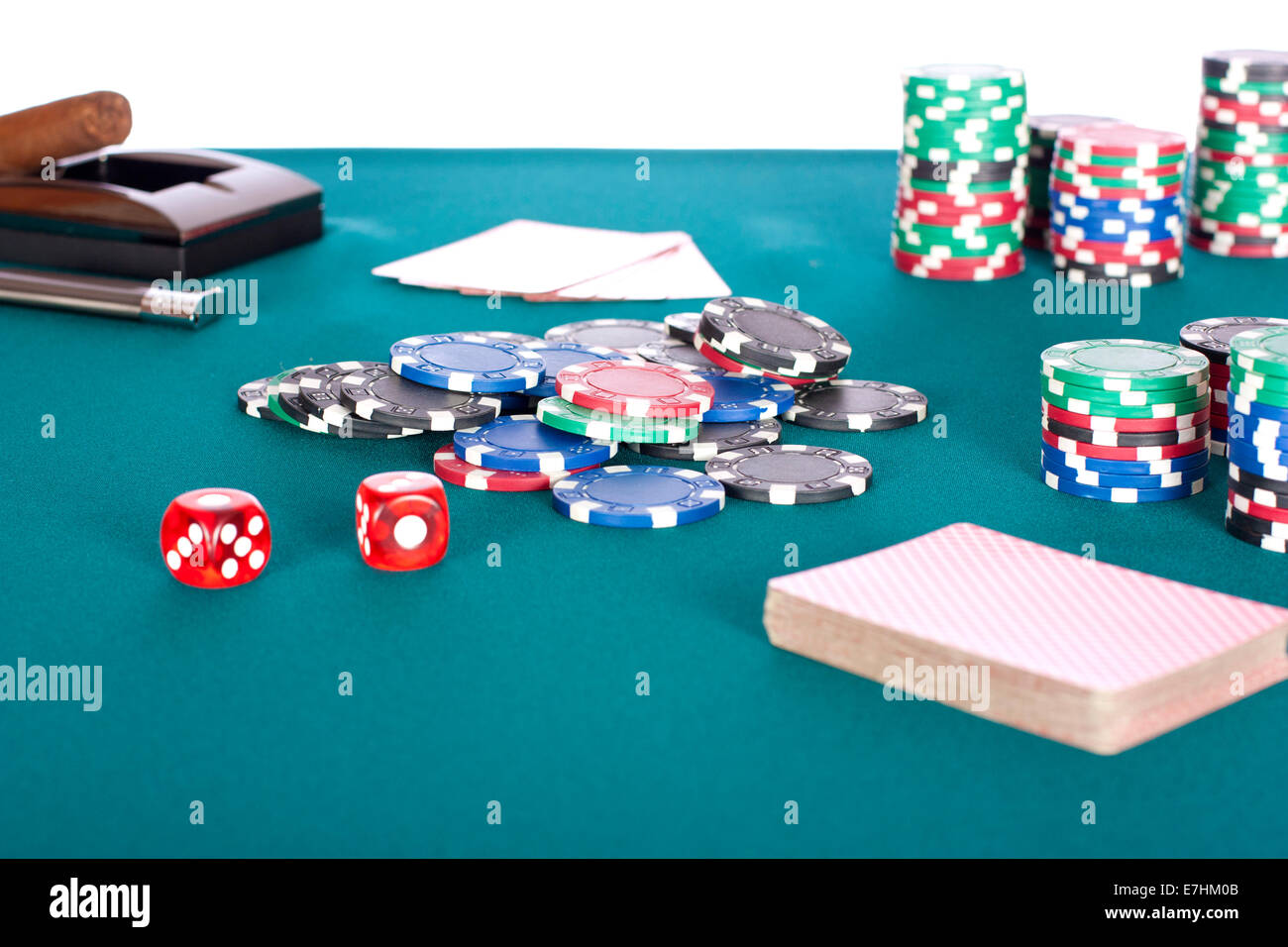 A selection of various value poker chips on a green felt poker table ...