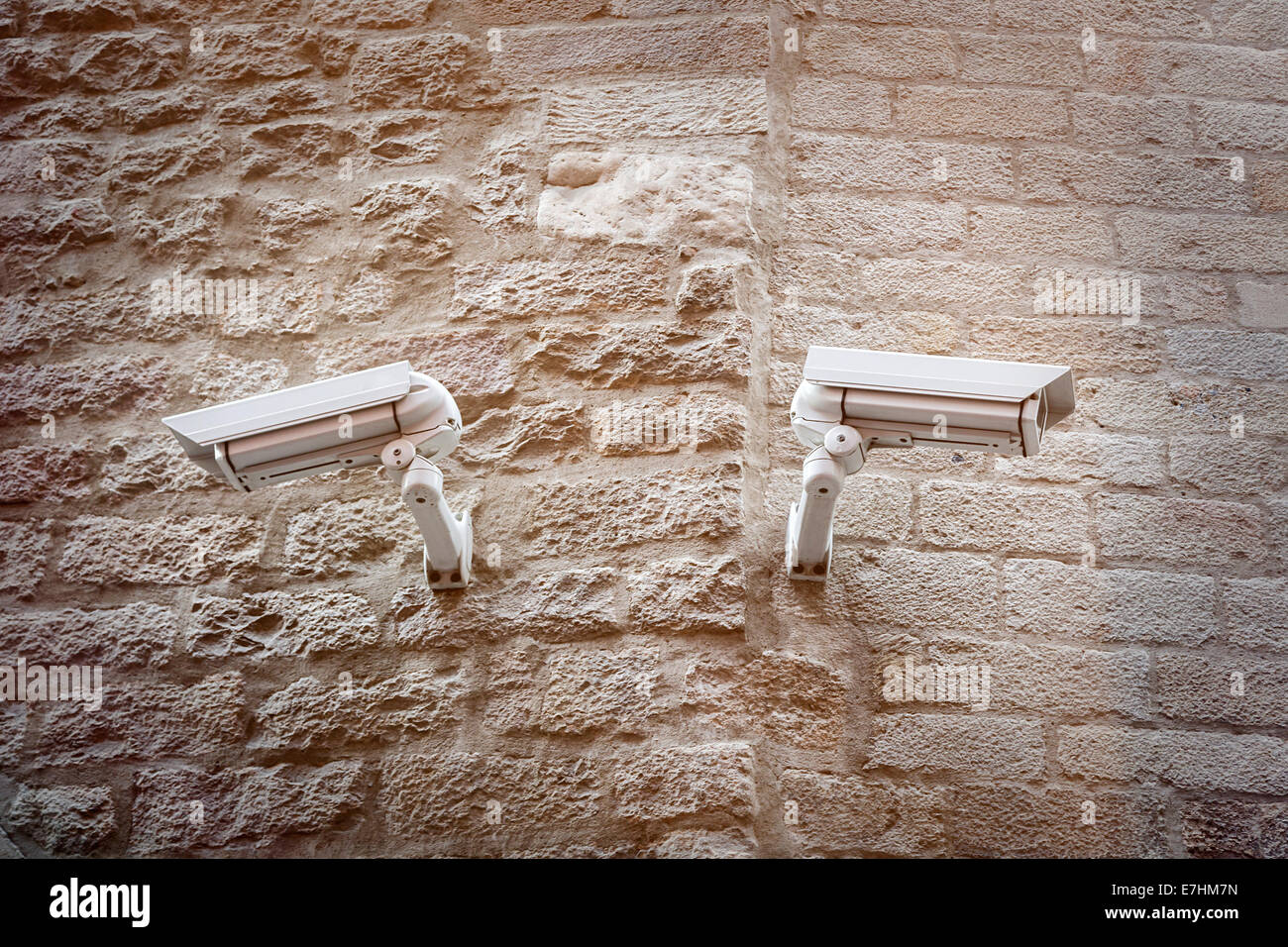 two observation cameras on a ancient natural stone wall Stock Photo - Alamy