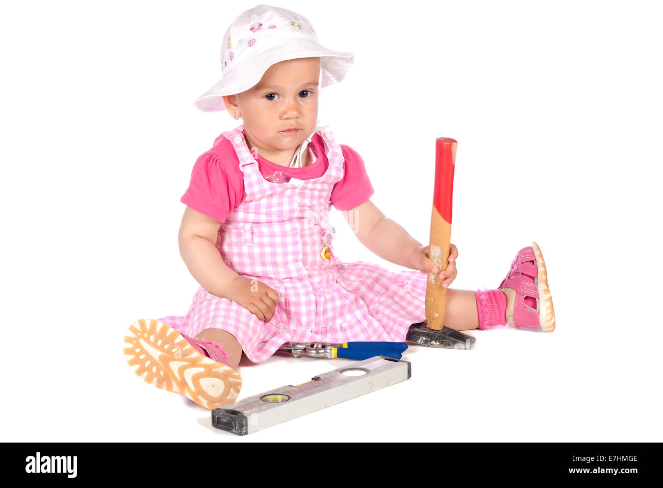 Baby girl with some tools in studio, isolated over white background ...