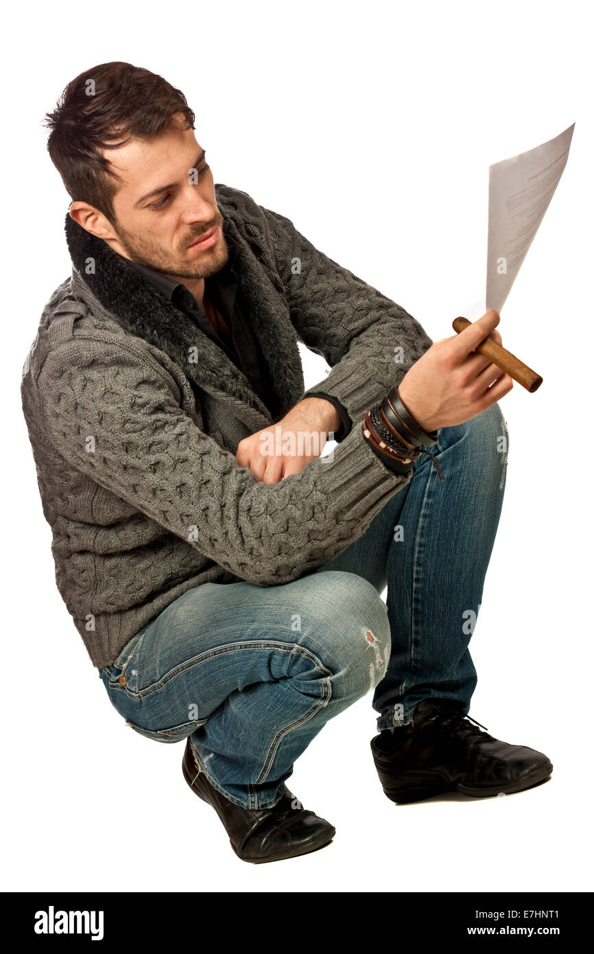 Young man reading one piece of paper, isolated over white background ...