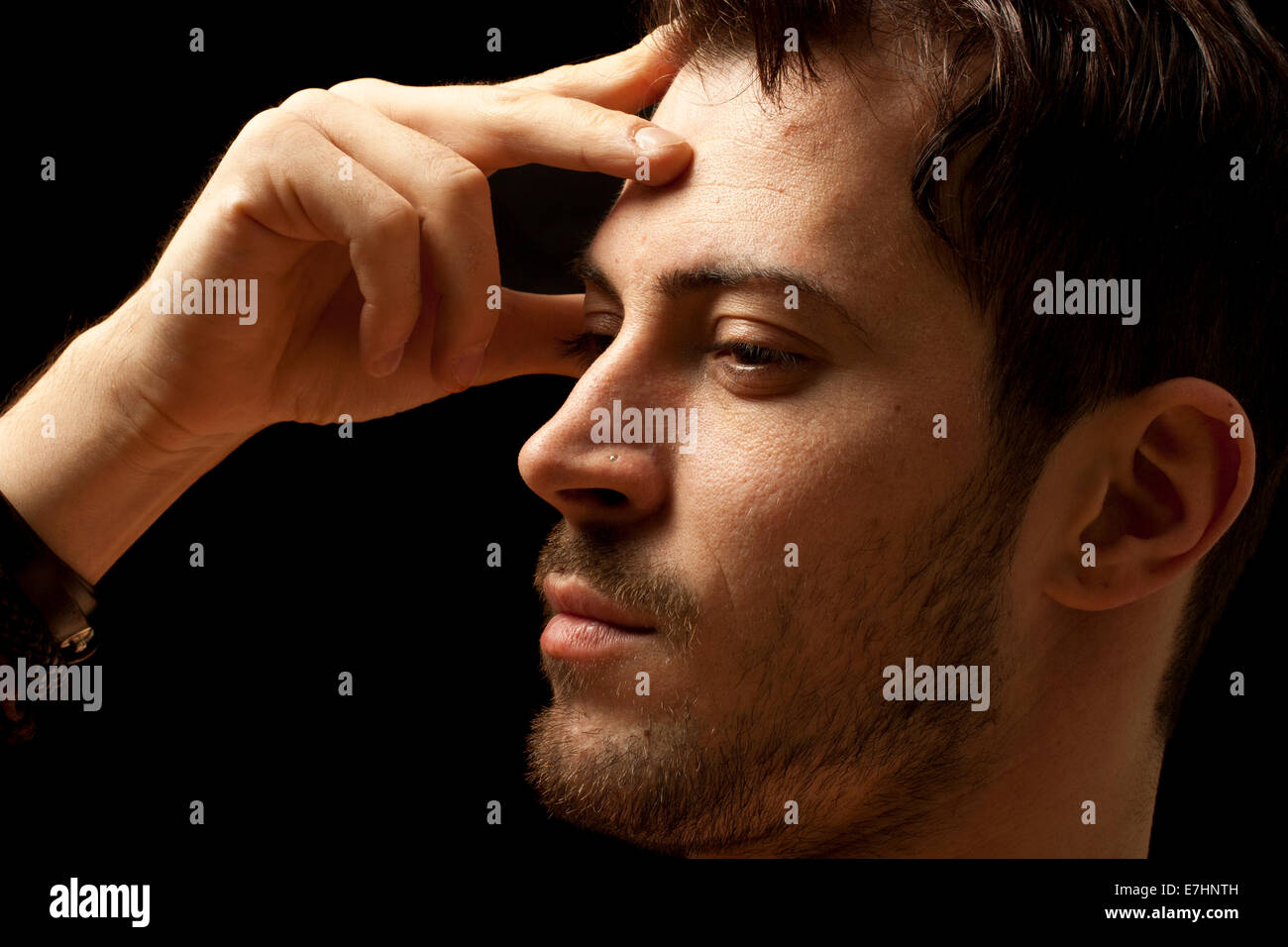Young man thinking about a solution , isolated on black Stock Photo - Alamy