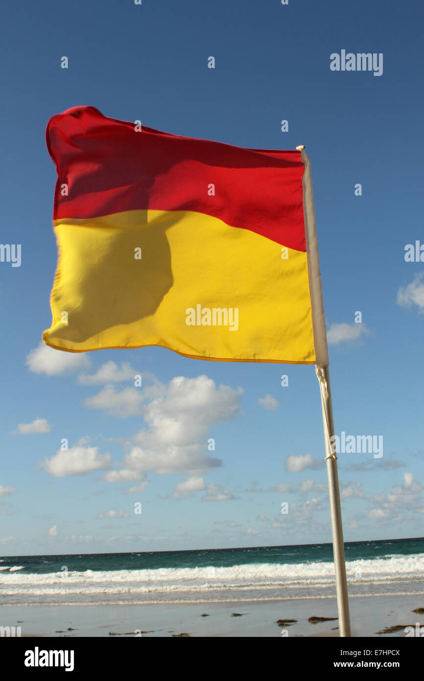 Danger swimming flag on the beach Stock Photo - Alamy