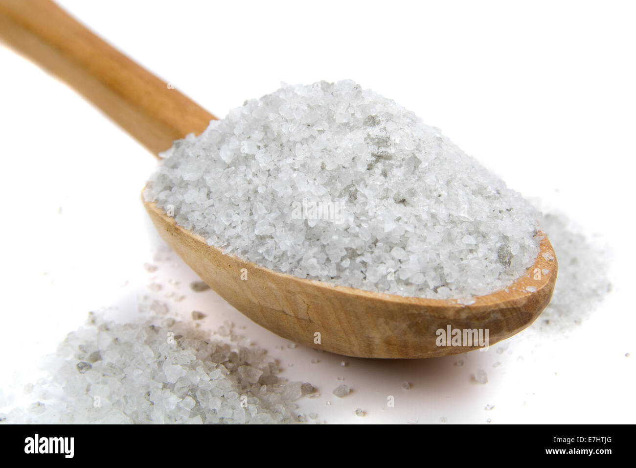 Wooden spoon full of salt on white background Stock Photo - Alamy