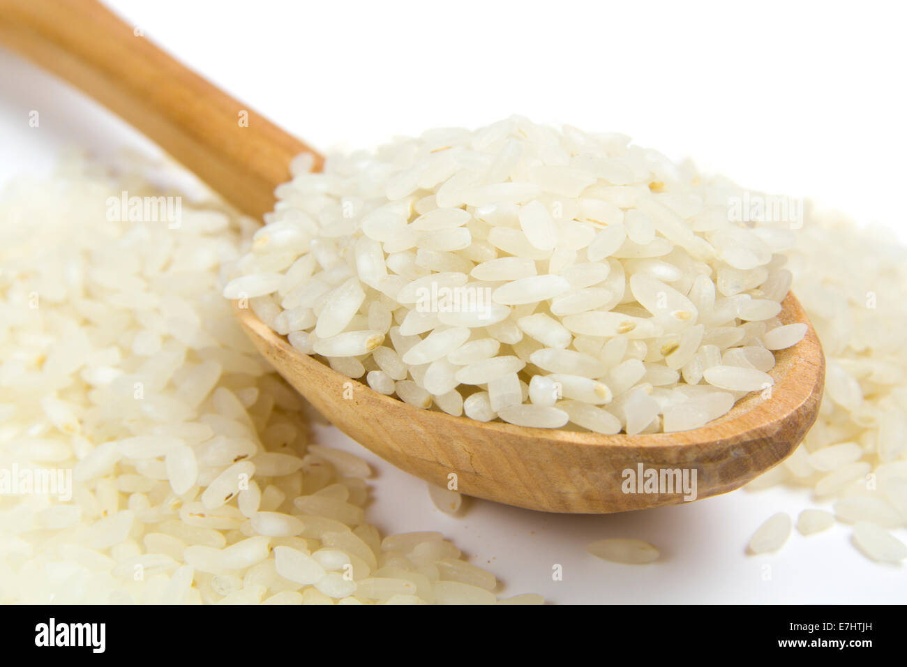 Rice grain in wooden old spoon isolated on white background Stock Photo ...