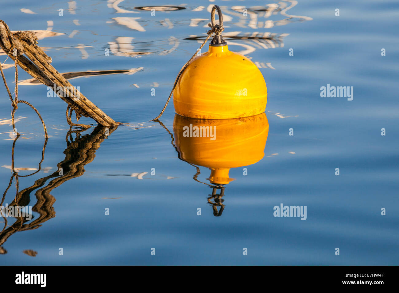 A floating yellow harbour buoy Stock Photo - Alamy