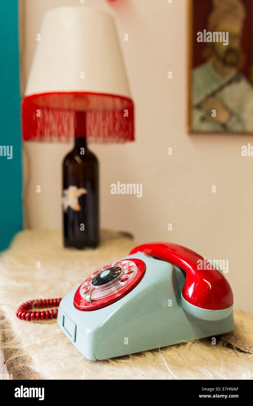 Turquoise green vintage telephone with red details in a shop Stock ...