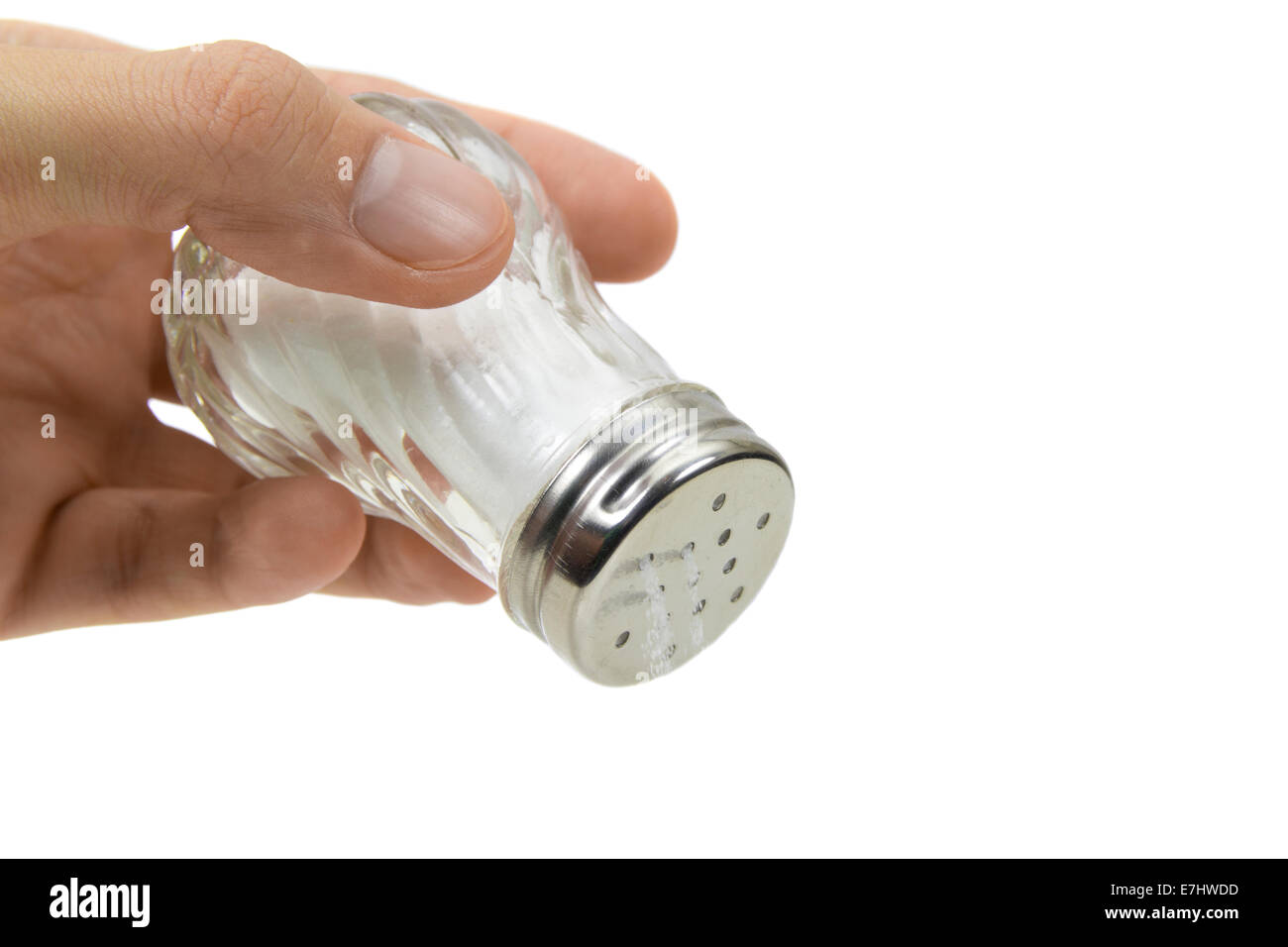 Hand holding salt cellar upside down isolated on white background Stock ...