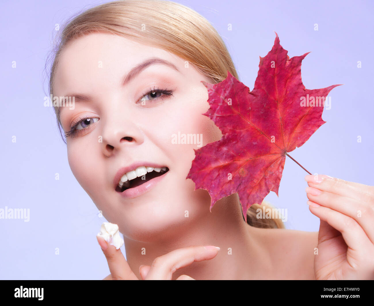 Skin care. Face of young woman girl with red maple leaf Stock Photo - Alamy