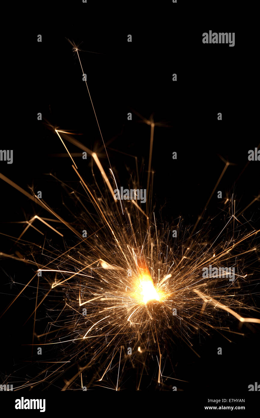 Burning sparklers in front of a black background Stock Photo - Alamy