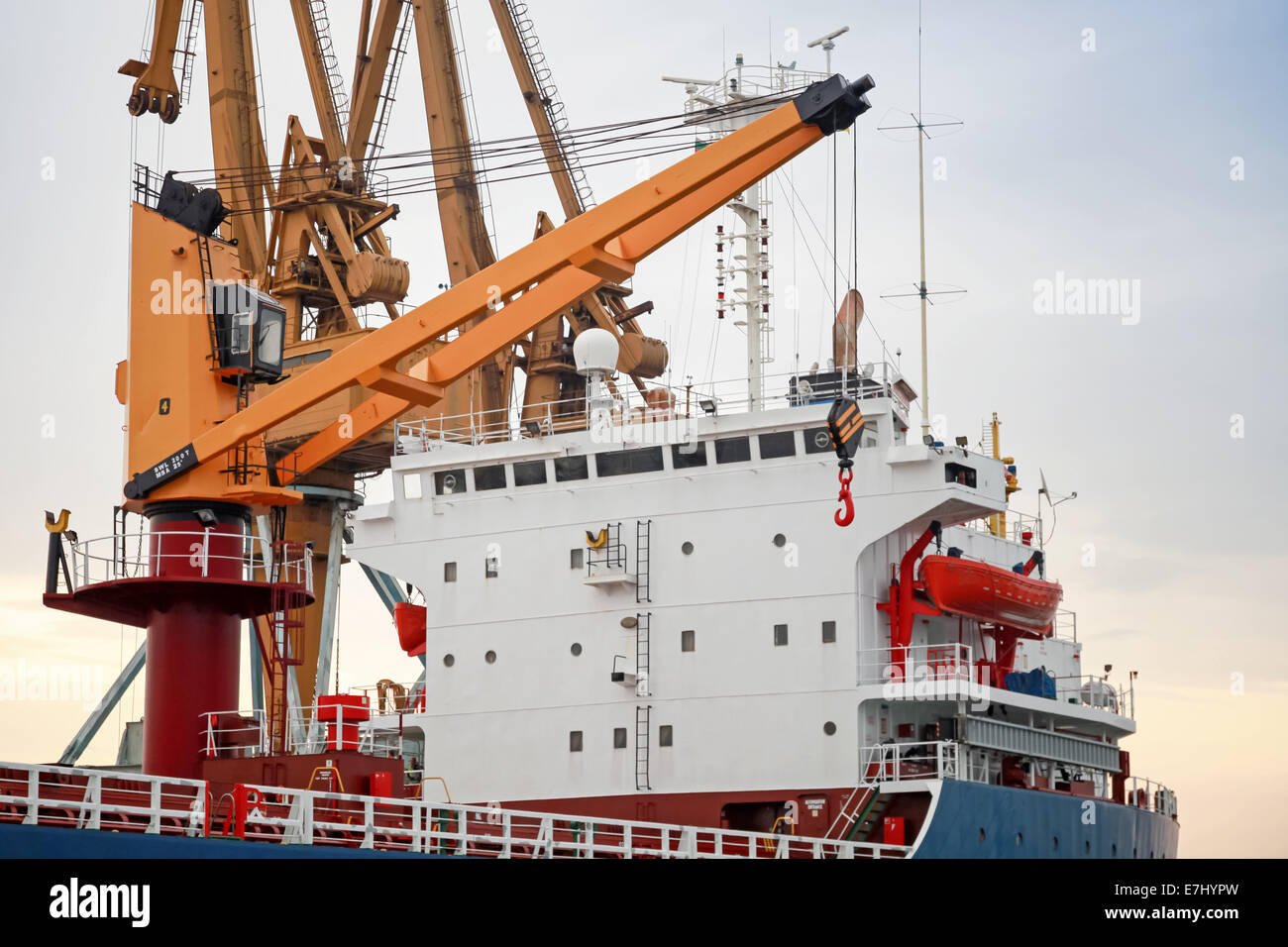 Big industrial cargo ship loading with cranes Stock Photo - Alamy