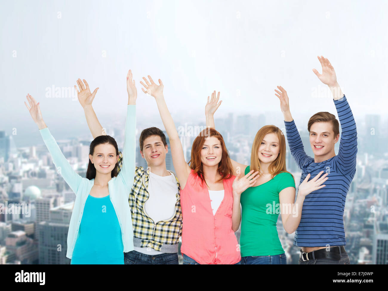 group of smiling students waving hands Stock Photo - Alamy