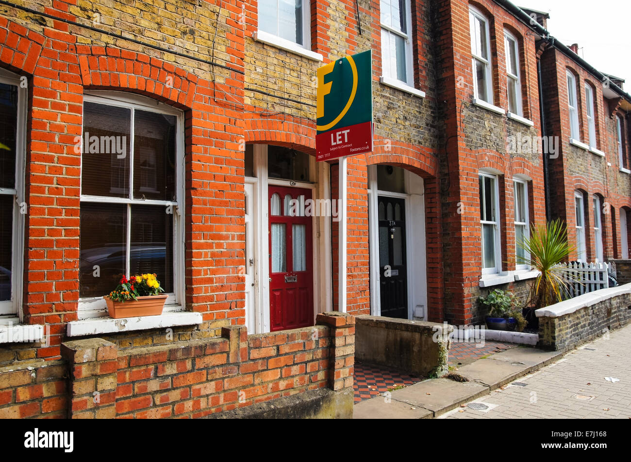 Foxtons real estate sign To Let outside terraced houses in South London ...