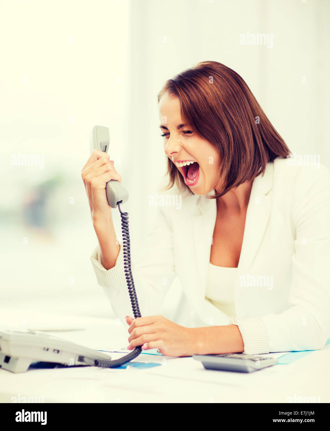 woman shouting into phone in office Stock Photo - Alamy