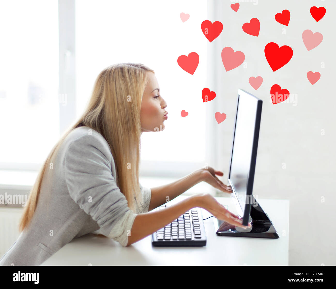 woman sending kisses with computer monitor Stock Photo - Alamy