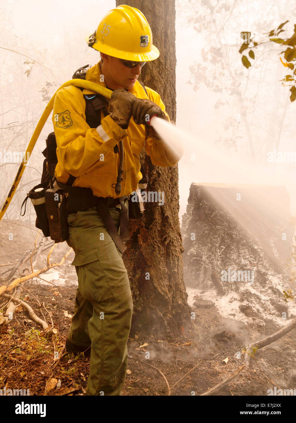 Hot shot crews spray water on embers from the Happy Camp Complex Fire ...