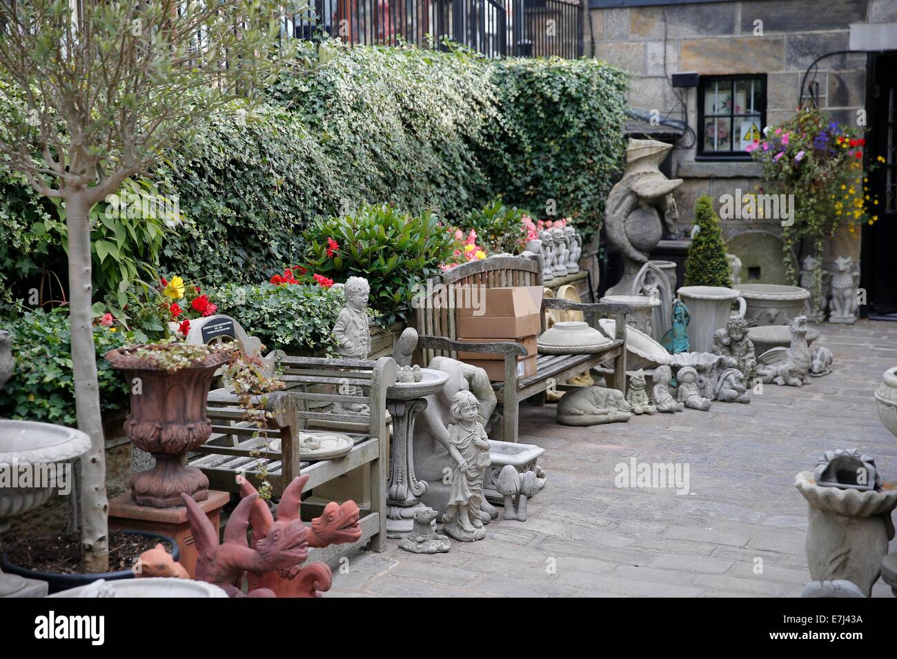 Garden statues and curiosity in a pretty courtyard Stock Photo - Alamy