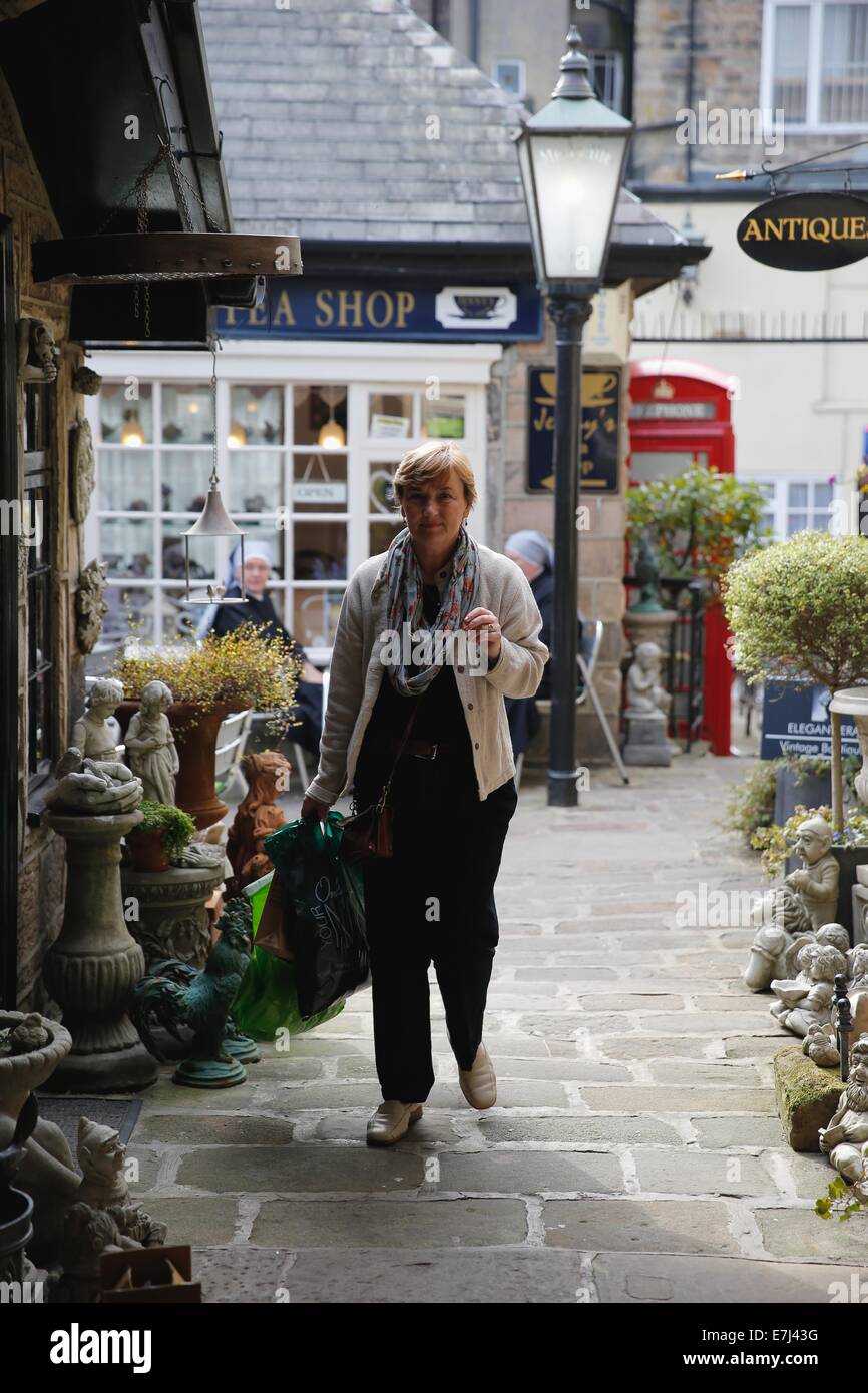 Two nuns sat enjoying tea at the café with lady walking through arch ...