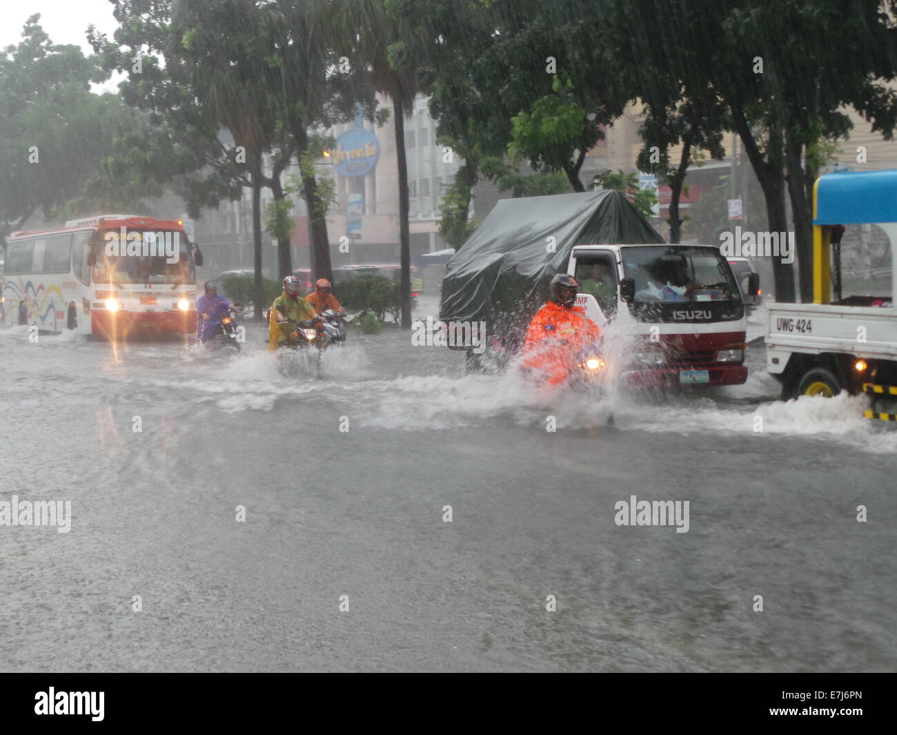 Vehicles passing thru Quezon Avenue as Typhoon Mario caused flooding in ...