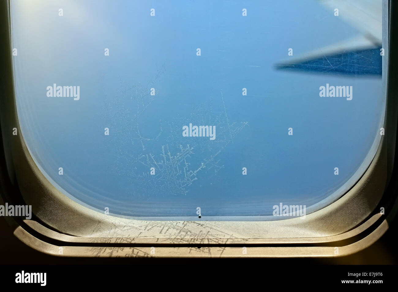 Ice on airplane window, with wings in background Stock Photo - Alamy