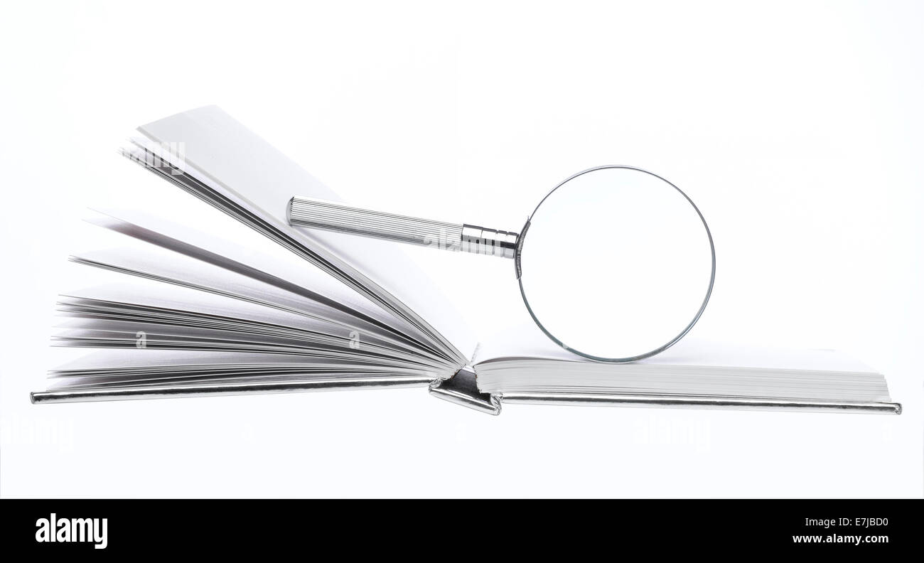 Magnifying Glass on open book Stock Photo - Alamy