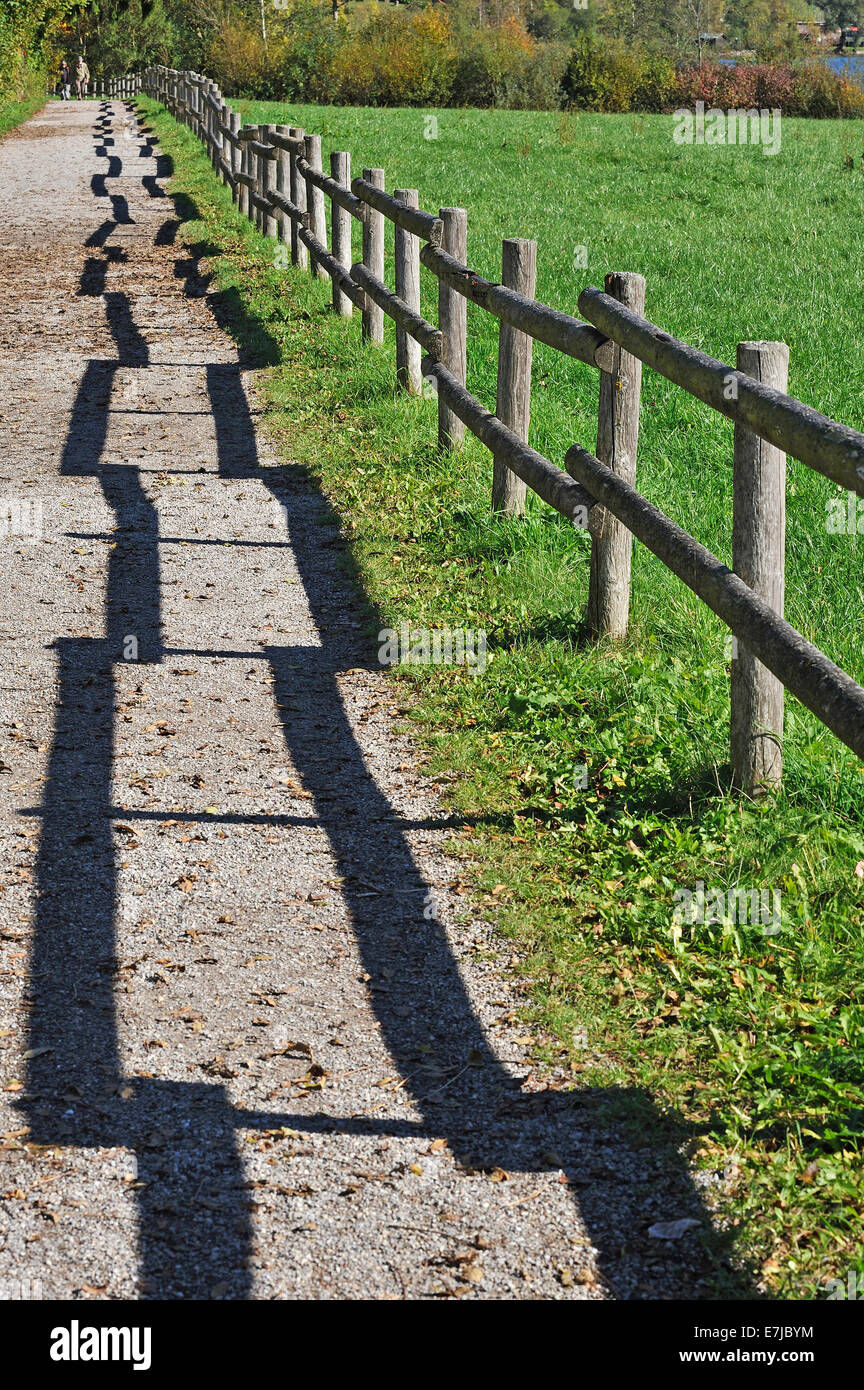 Fence with a shadow along the promenade path, Bühl am Alpsee, Allgäu ...